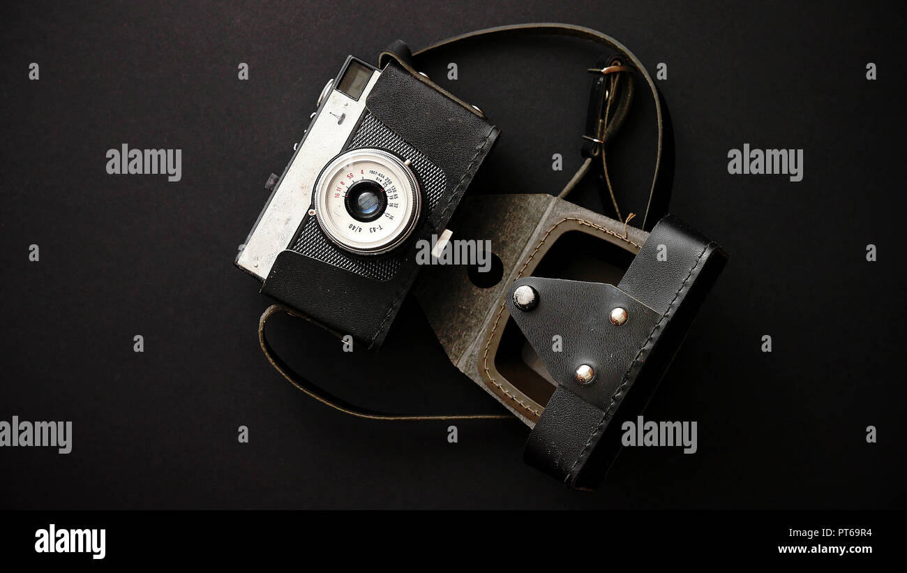 Old retro film camera in leather case on black background Stock Photo ...