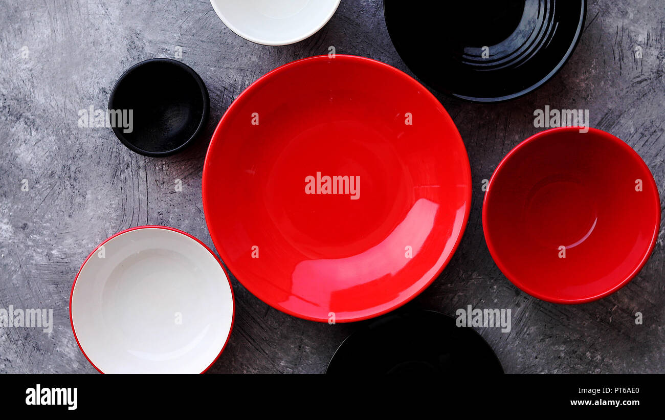 Collection of empty colorful decorative ceramic bowls on grey stone ...