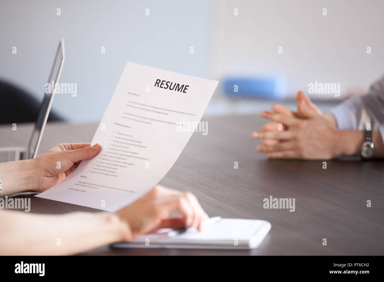 Hr holding reading resume at job interview, close up view Stock Photo ...