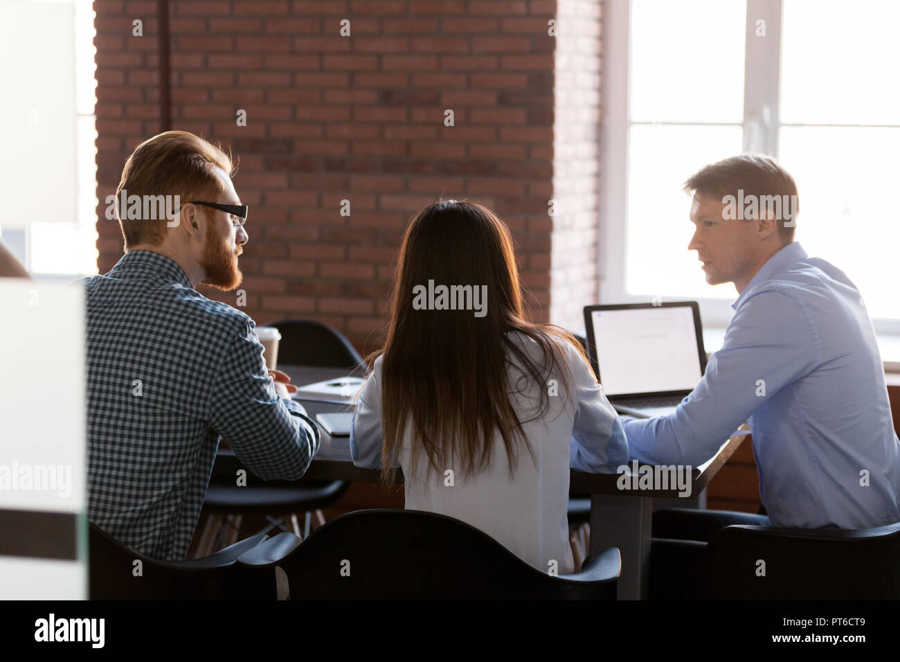 Rear view at business team people talking at office meeting Stock Photo ...