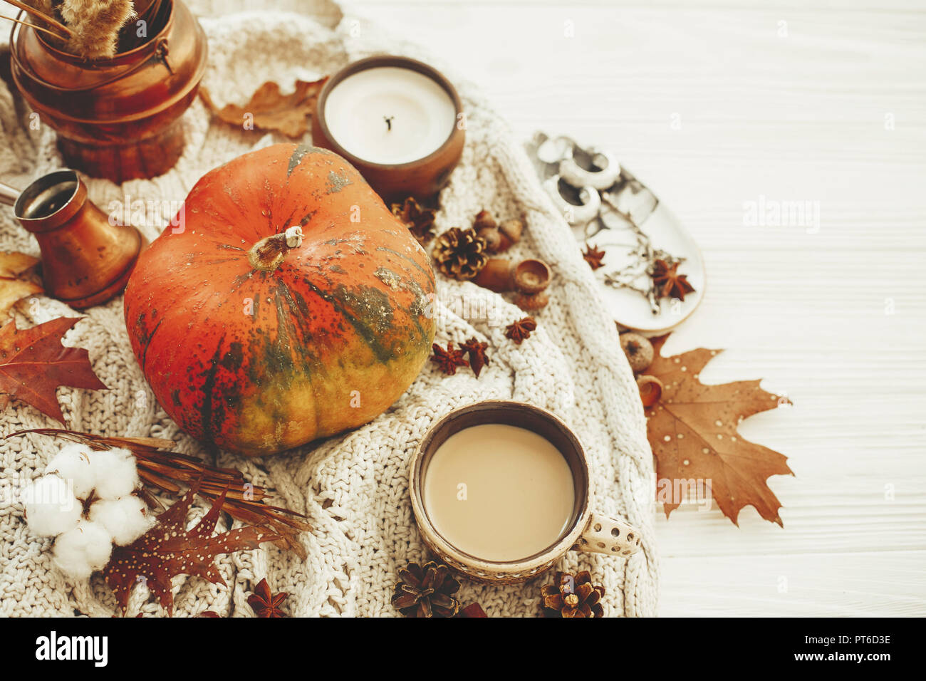 Happy Thanksgiving concept. Pumpkin, coffee, candle, fall leaves ...