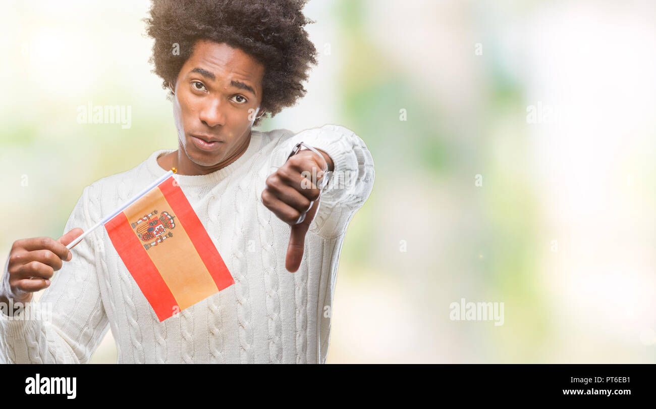 Afro american man flag of Spain over isolated background with angry ...