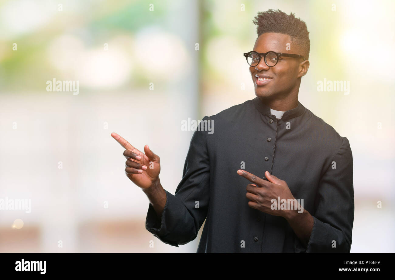 Young african american priest man over isolated background smiling and ...
