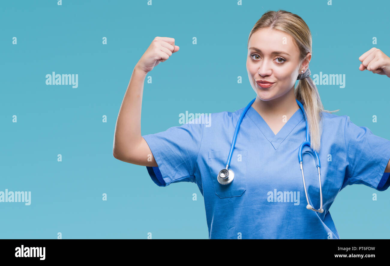 Young blonde surgeon doctor woman over isolated background showing arms ...