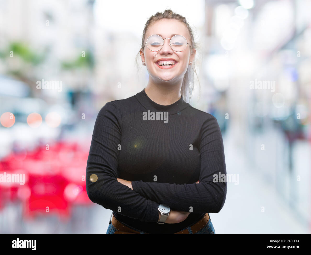 Young blonde woman wearing glasses over isolated background happy face ...