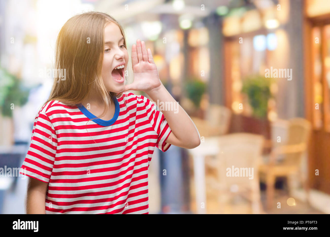 Young beautiful girl over isolated background shouting and screaming ...