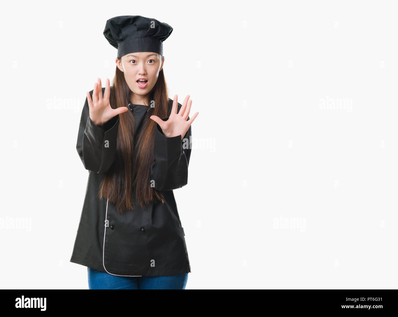 Young Chinese woman over isolated background wearing chef uniform ...