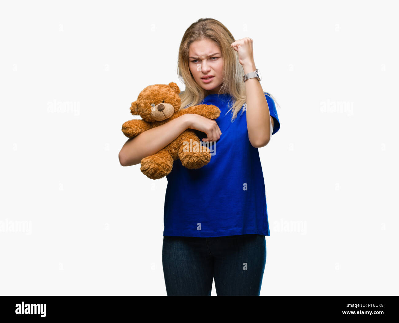 Young caucasian woman holding cute teddy bear over isolated background ...