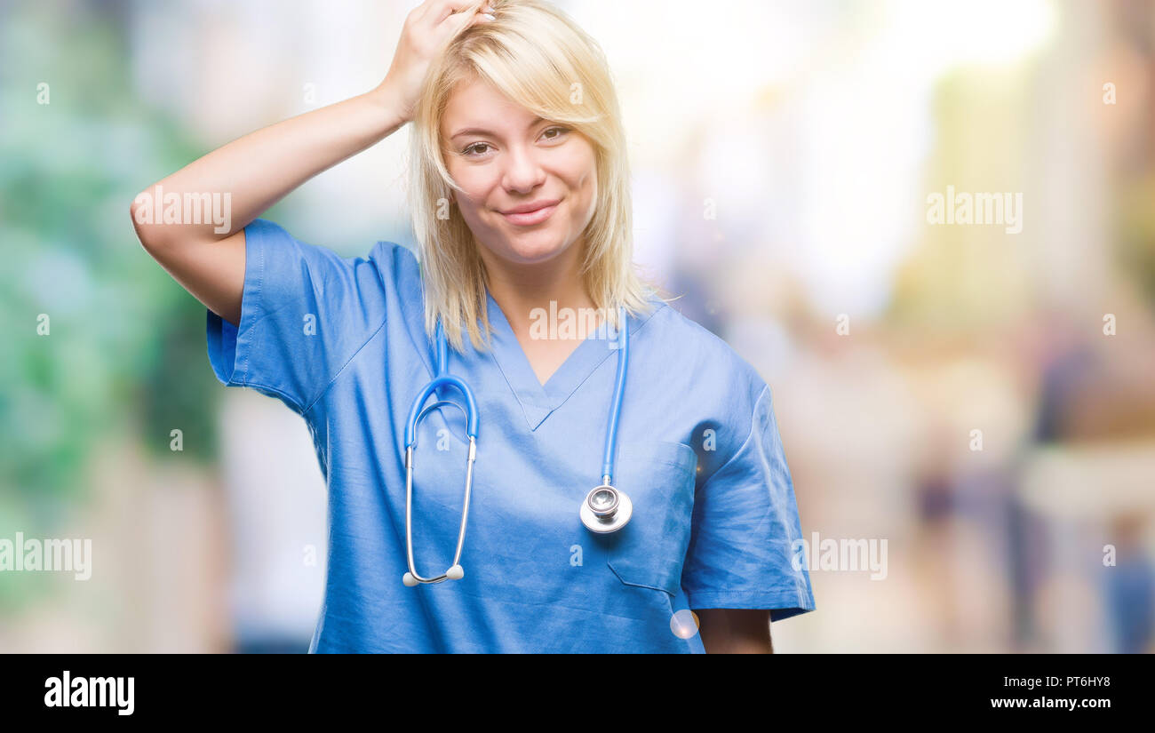 Young beautiful blonde doctor woman wearing medical uniform over ...