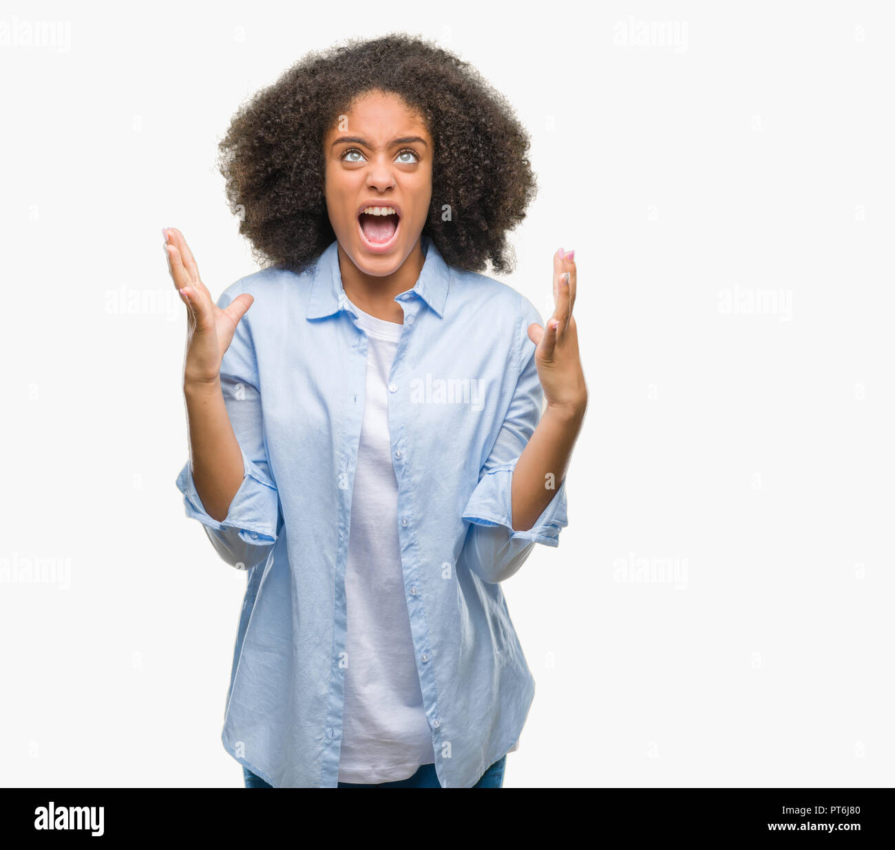 Young afro american woman over isolated background crazy and mad ...