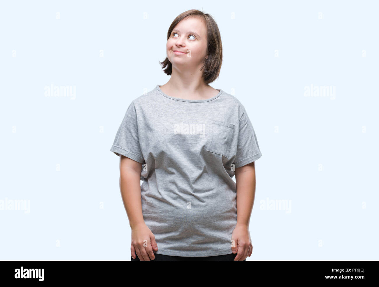 Young adult woman with down syndrome over isolated background smiling ...