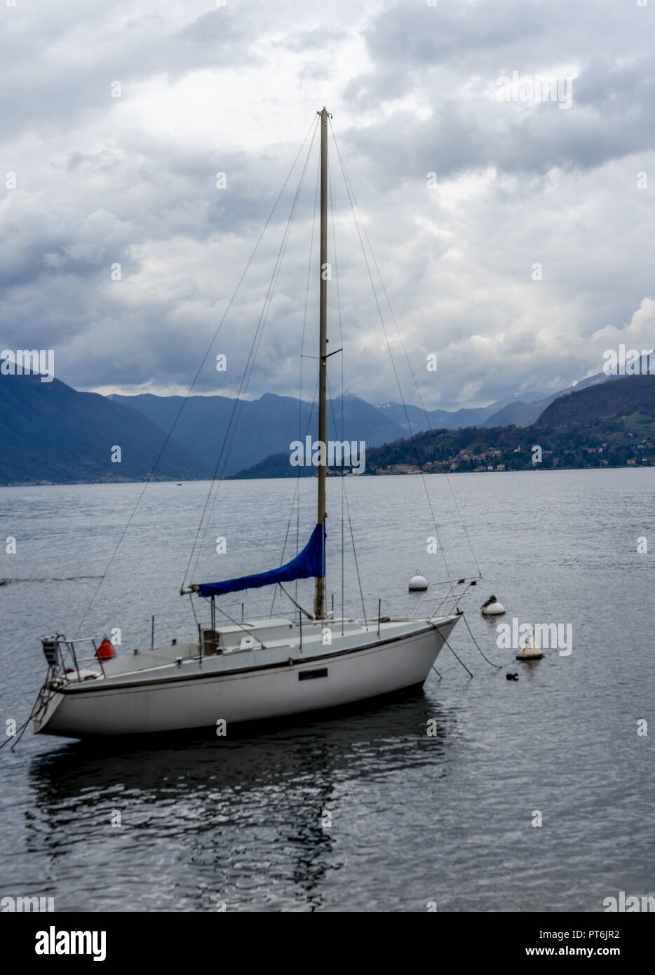 Europe, Italy, Varenna, Lake Como, a small boat in a body of water with ...