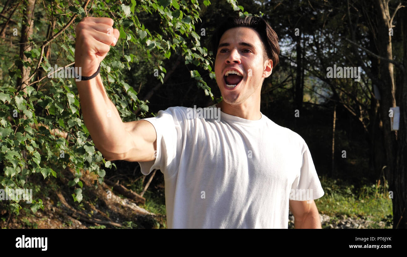 Young man exulting happy in nature, standing Stock Photo - Alamy