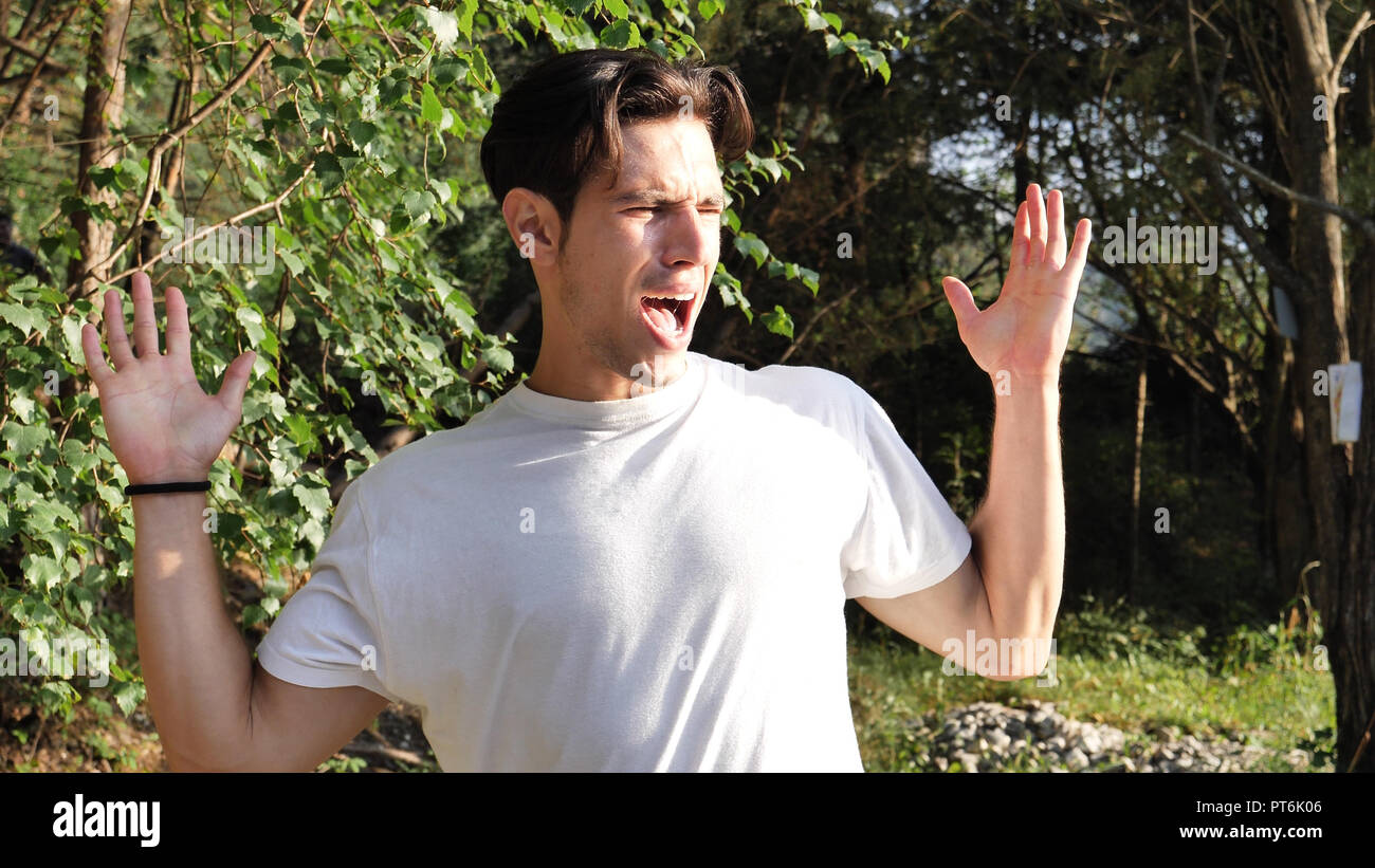 Young man frustrated for too much noise in nature Stock Photo - Alamy