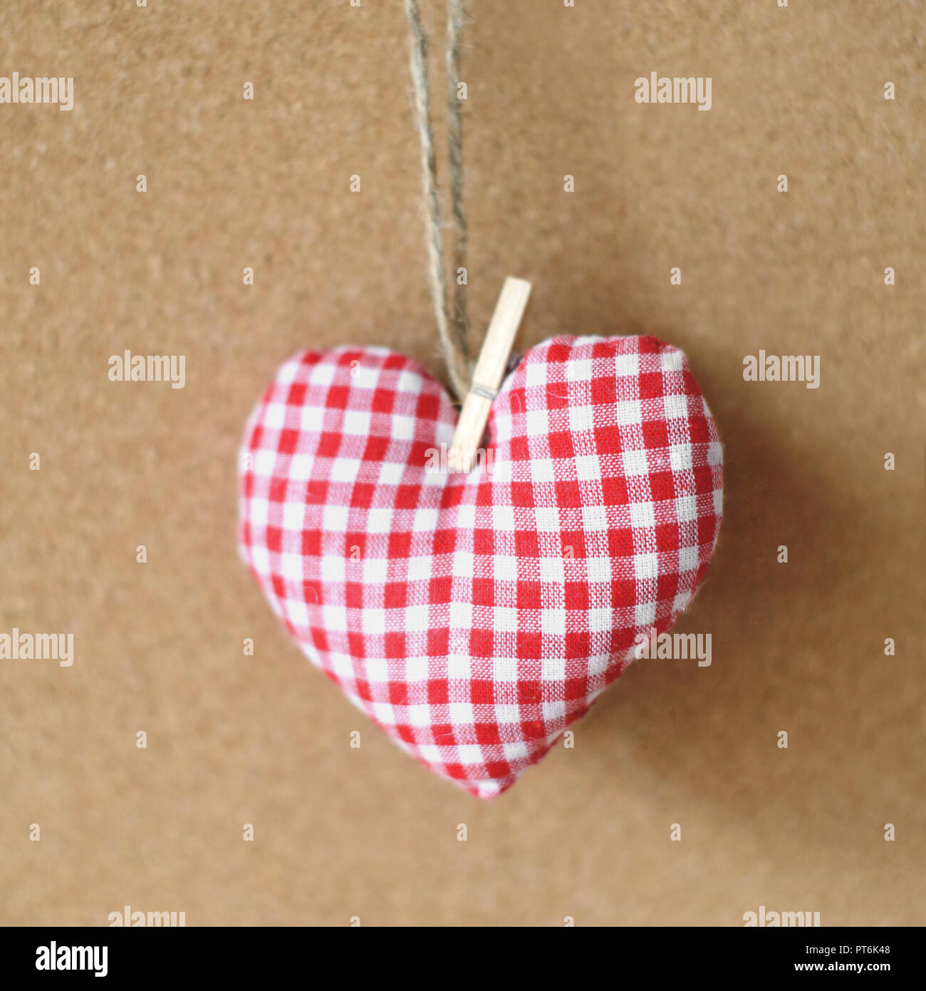 Red textile heart over brown craft recycle cork board background ...