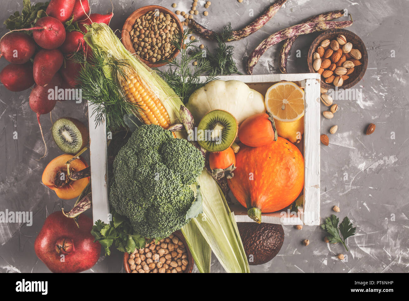 Autumn harvest food in a wooden box. Fruits, vegetables and cereals ...