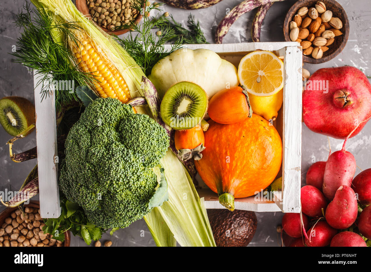 Autumn harvest food in a wooden box. Fruits, vegetables and cereals ...