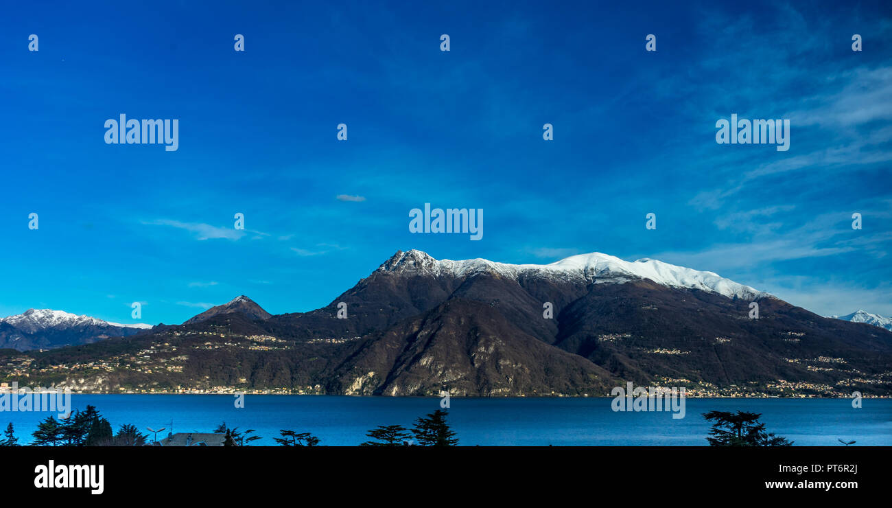 Italy, Bellagio, Lake Como with snow capped alps mountain Stock Photo ...