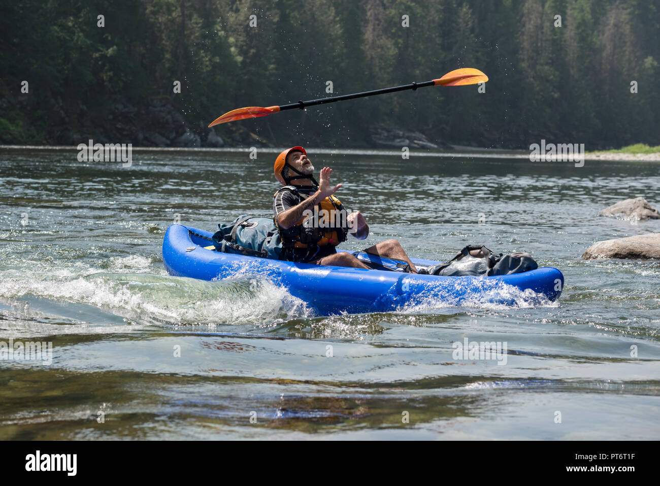 Surfing a wave in an inflatable kayak on Idaho's Selway River Stock ...