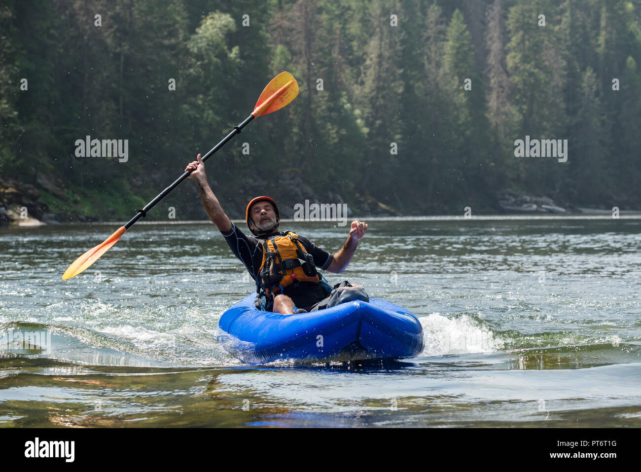 Surfing a wave in an inflatable kayak on Idaho's Selway River Stock ...