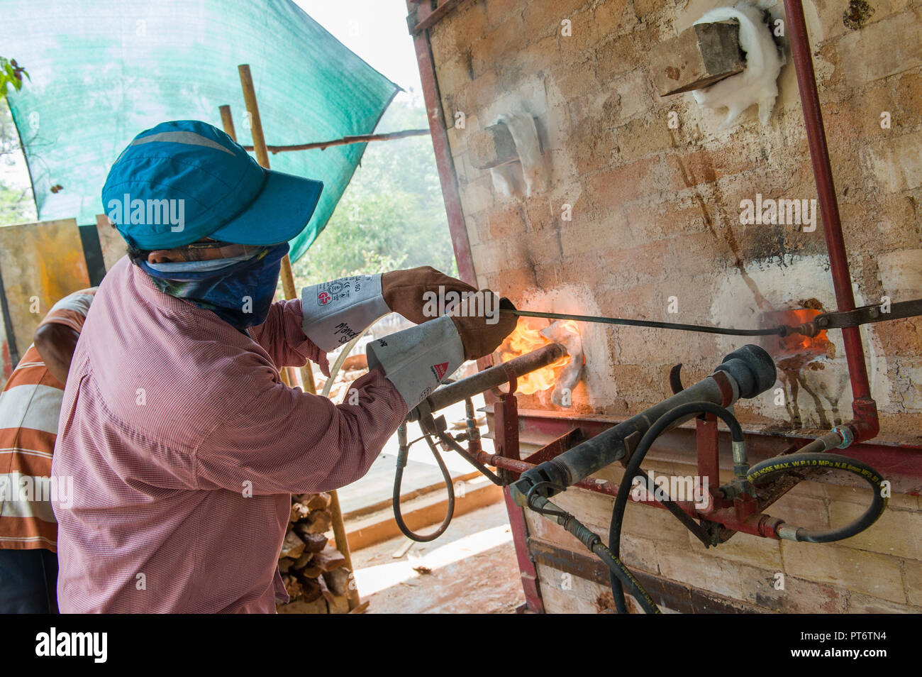 TAMIL NADU, INDIA - April 2018: Soda firing process in pottery ...