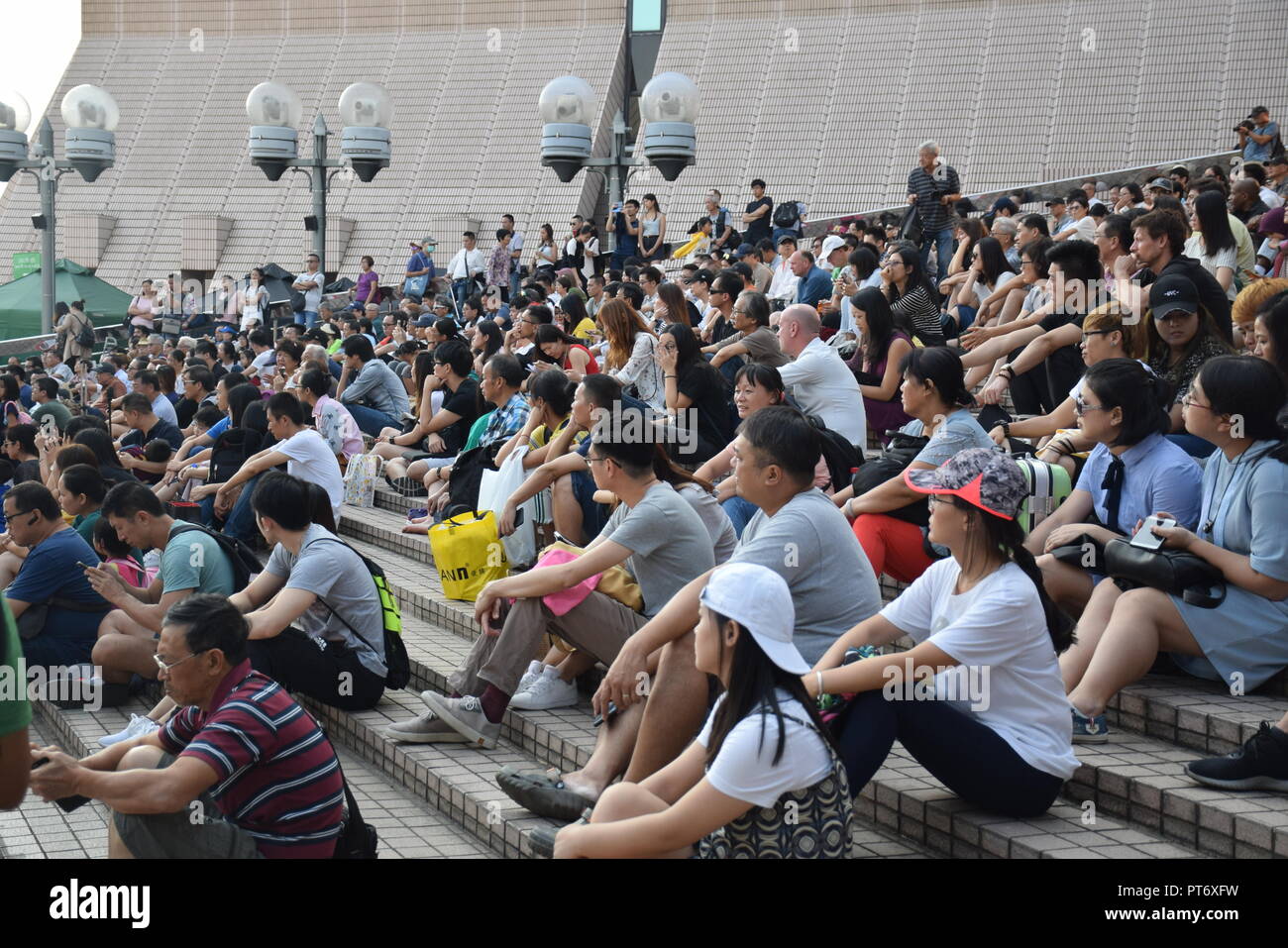 Crowd of asian people sitting on the steps during a concert in Hong ...