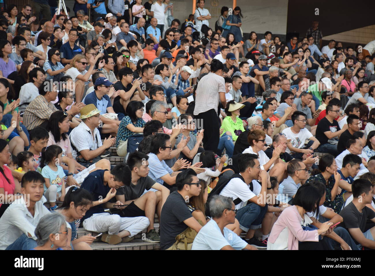 Crowd of asian people sitting on the steps during a concert in Hong ...