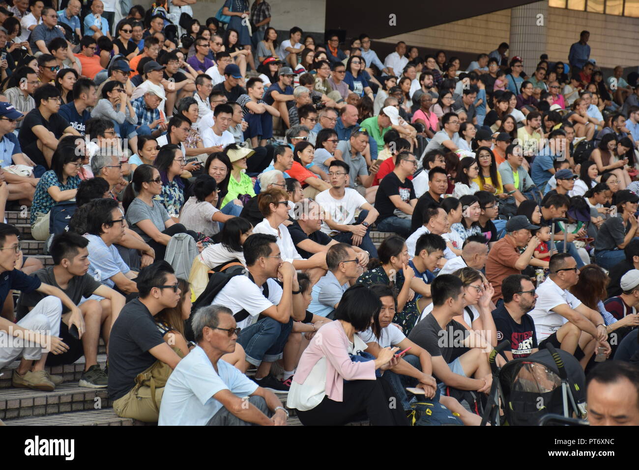 Crowd of asian people sitting on the steps during a concert in Hong ...