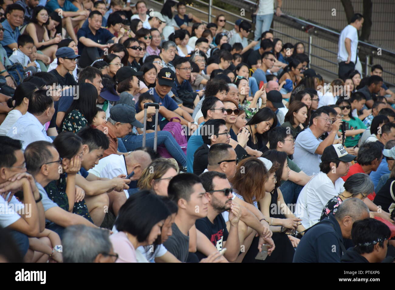 Crowd of asian people sitting on the steps during a concert in Hong ...