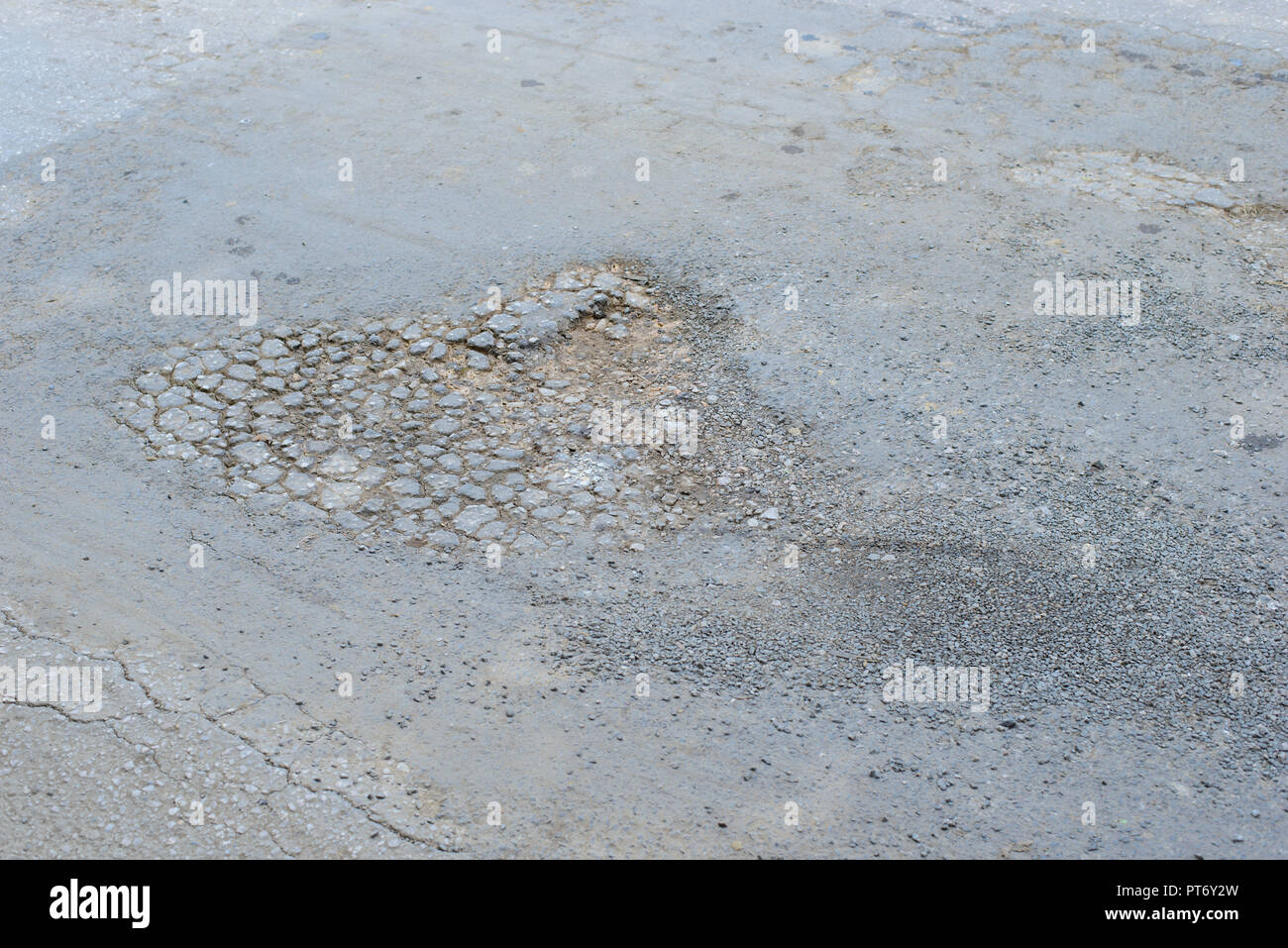 Large pit with stones on the asphalt highway Stock Photo - Alamy