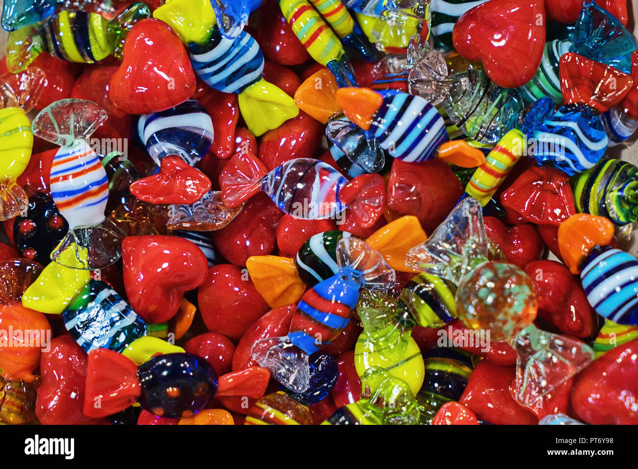 Close up background texture of multicolored glass candy and hearts ...