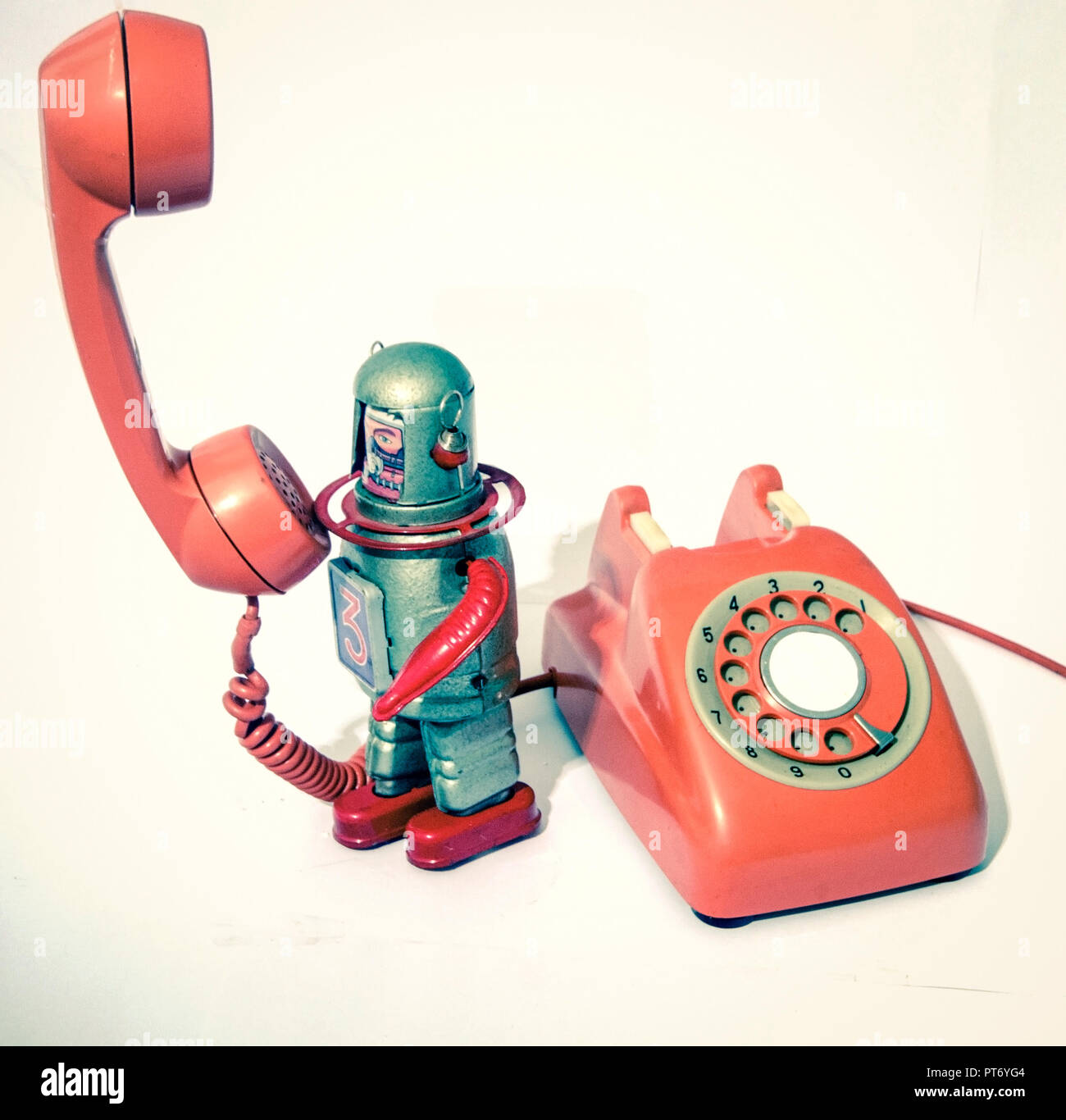 retro robot on an old phone robot calls toned image Stock Photo - Alamy