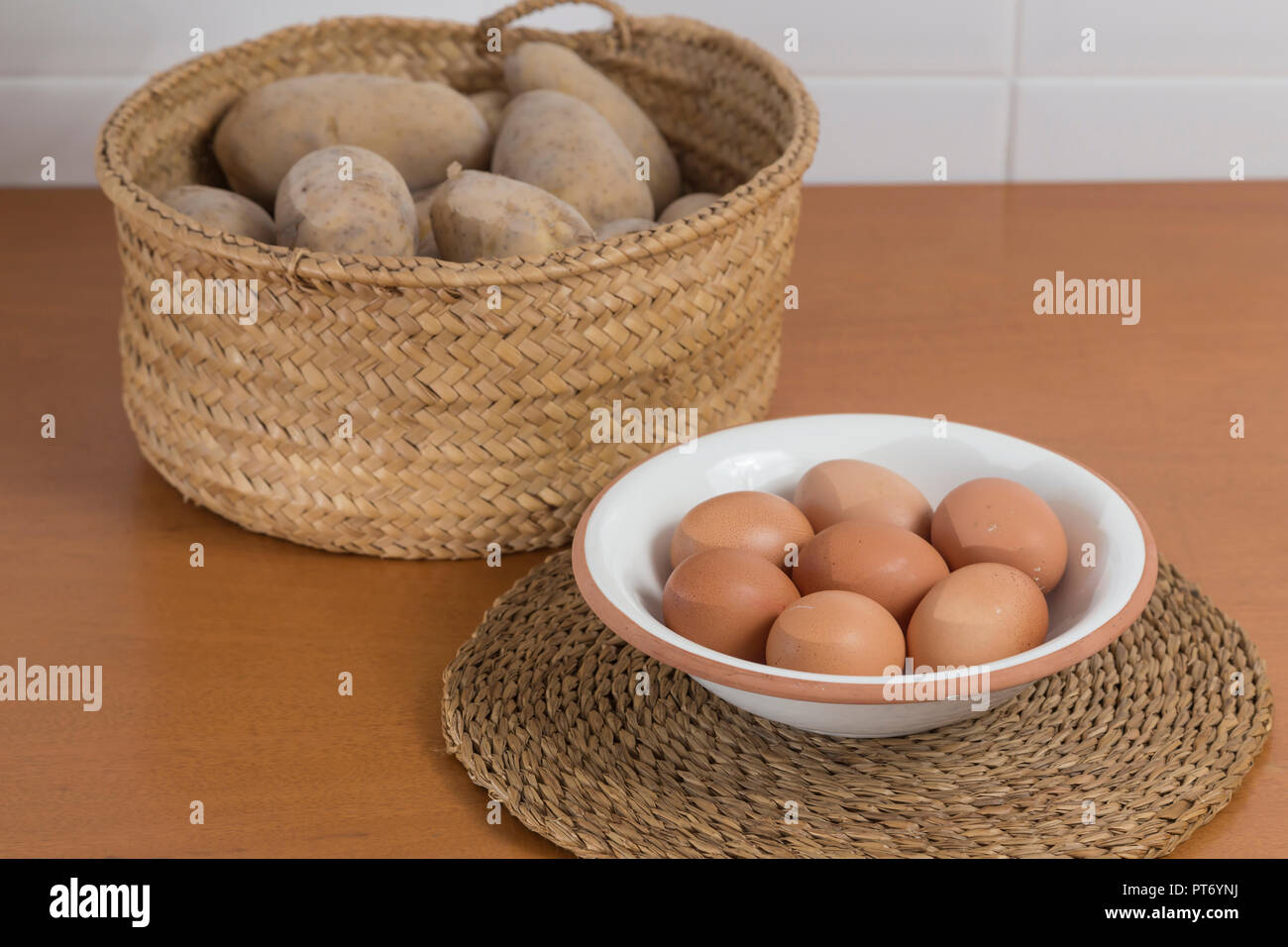 dish with seven eggs on a surface of rope and basket of rope with ...