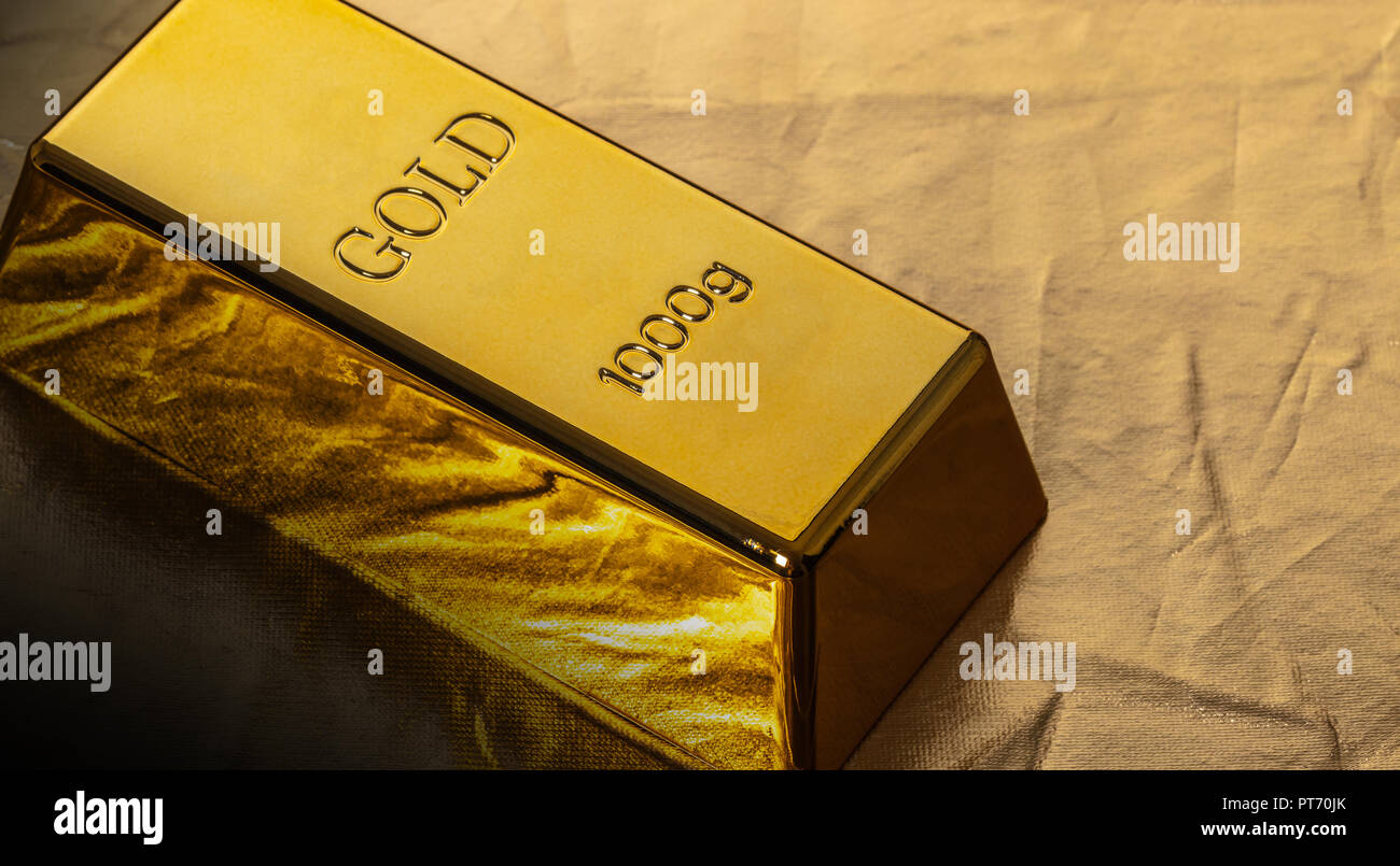 bar of gold close-up on golden background Stock Photo - Alamy