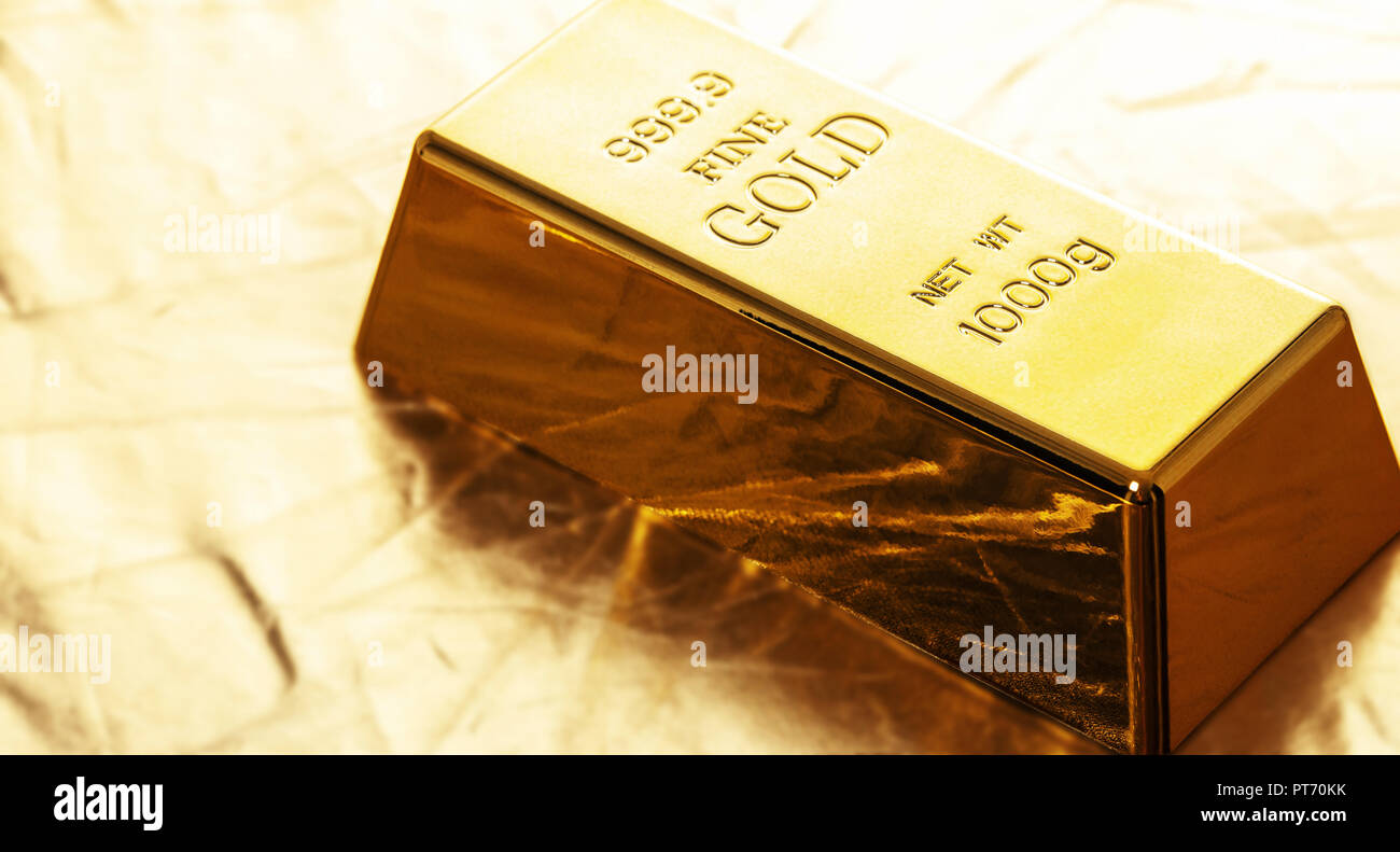 bar of gold close-up on golden background Stock Photo - Alamy