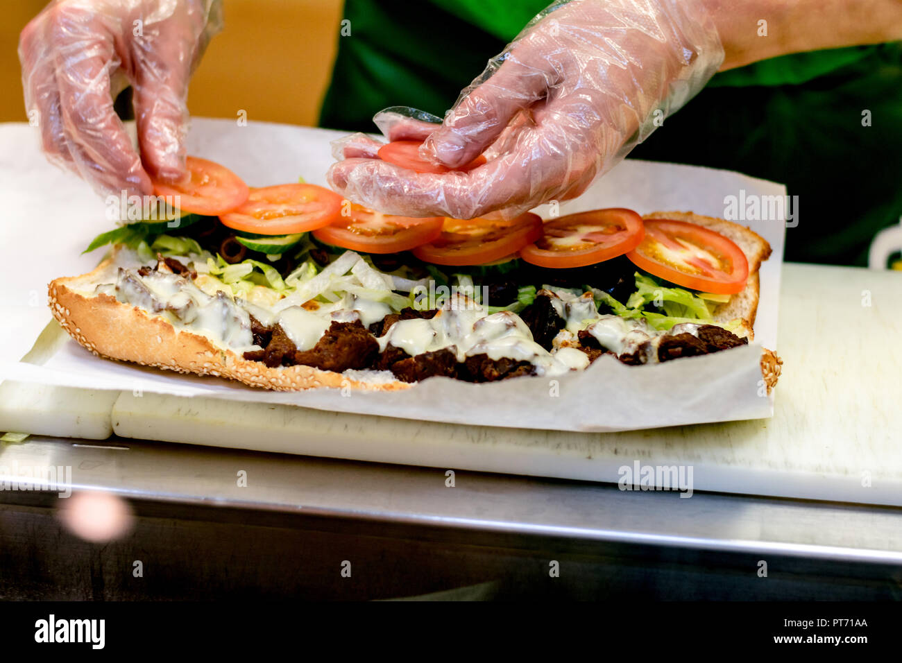 the seller at the fast food bar prepares a sandwich Stock Photo - Alamy