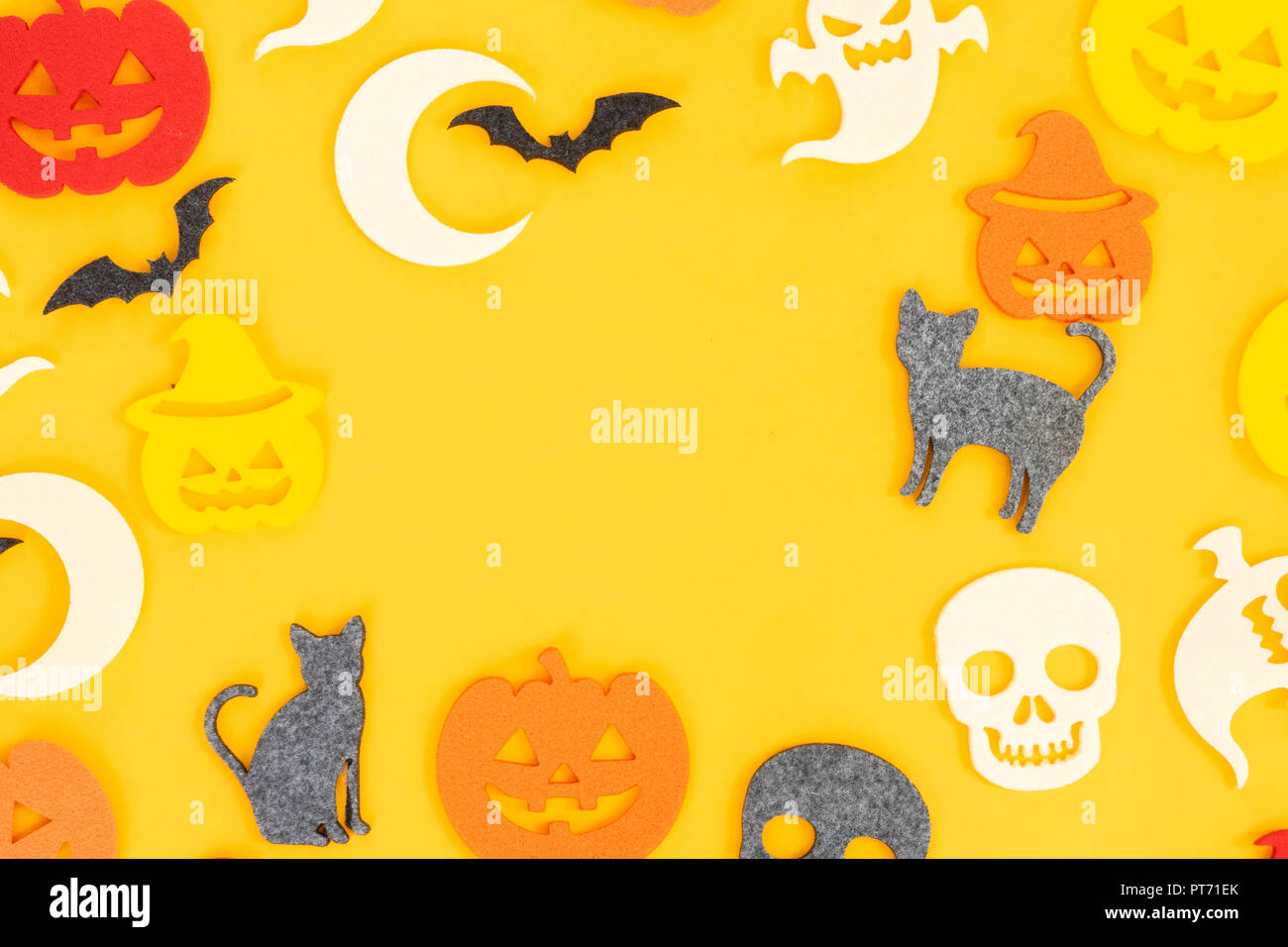 Halloween flat lay pattern frame on yellow background with copy space ...
