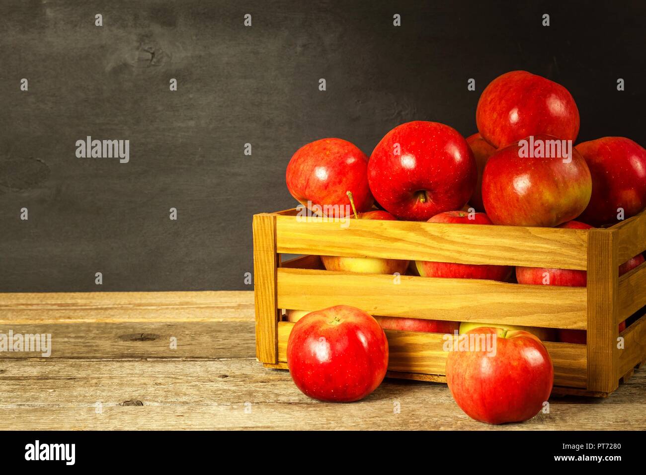 Fresh apples on an old wooden table. Black background. Autumn harvest ...
