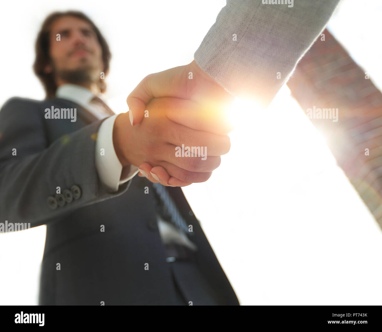 Side view close-up of two young man shaking hands Stock Photo - Alamy