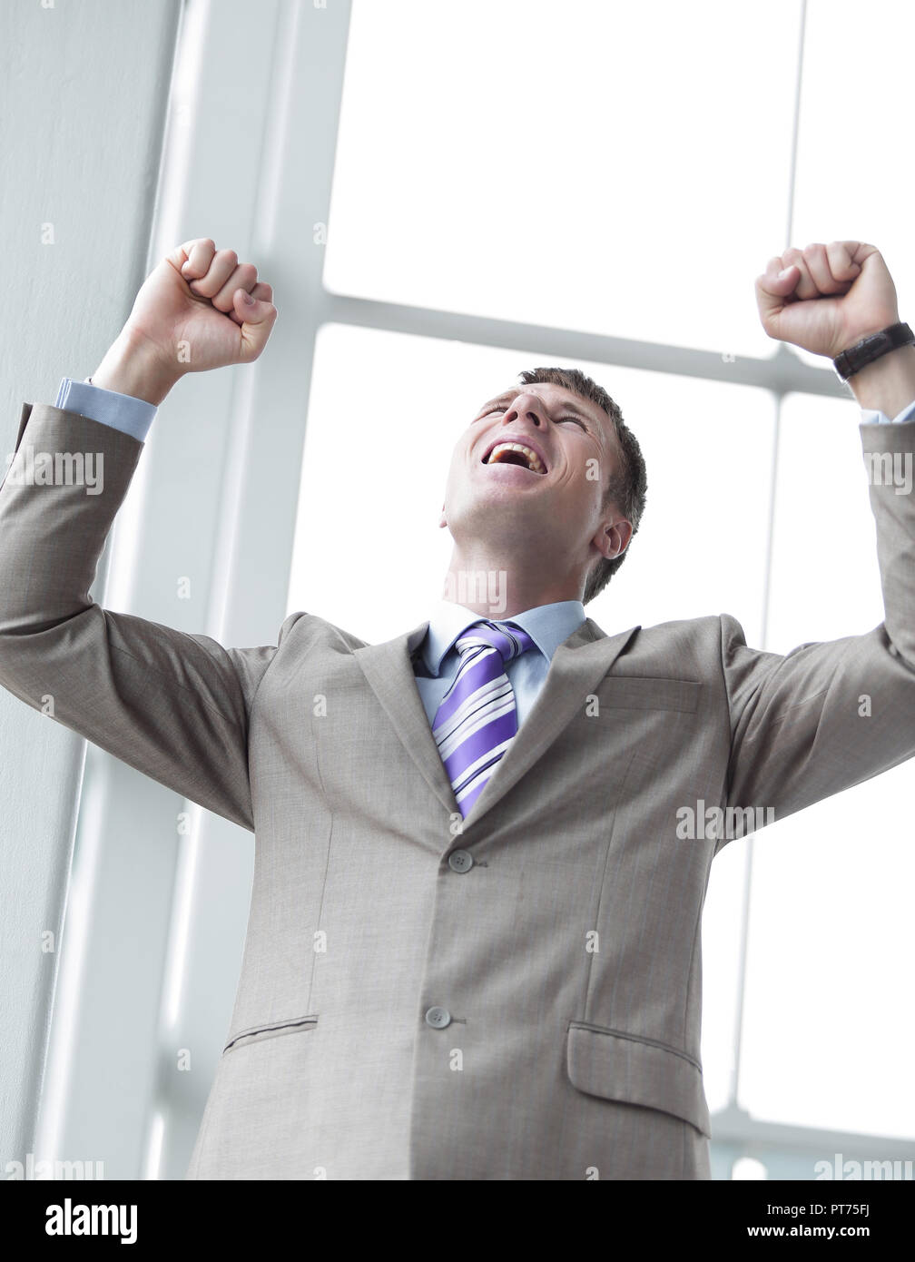 Shouting with joyful young entrepreneur raised hands Stock Photo - Alamy