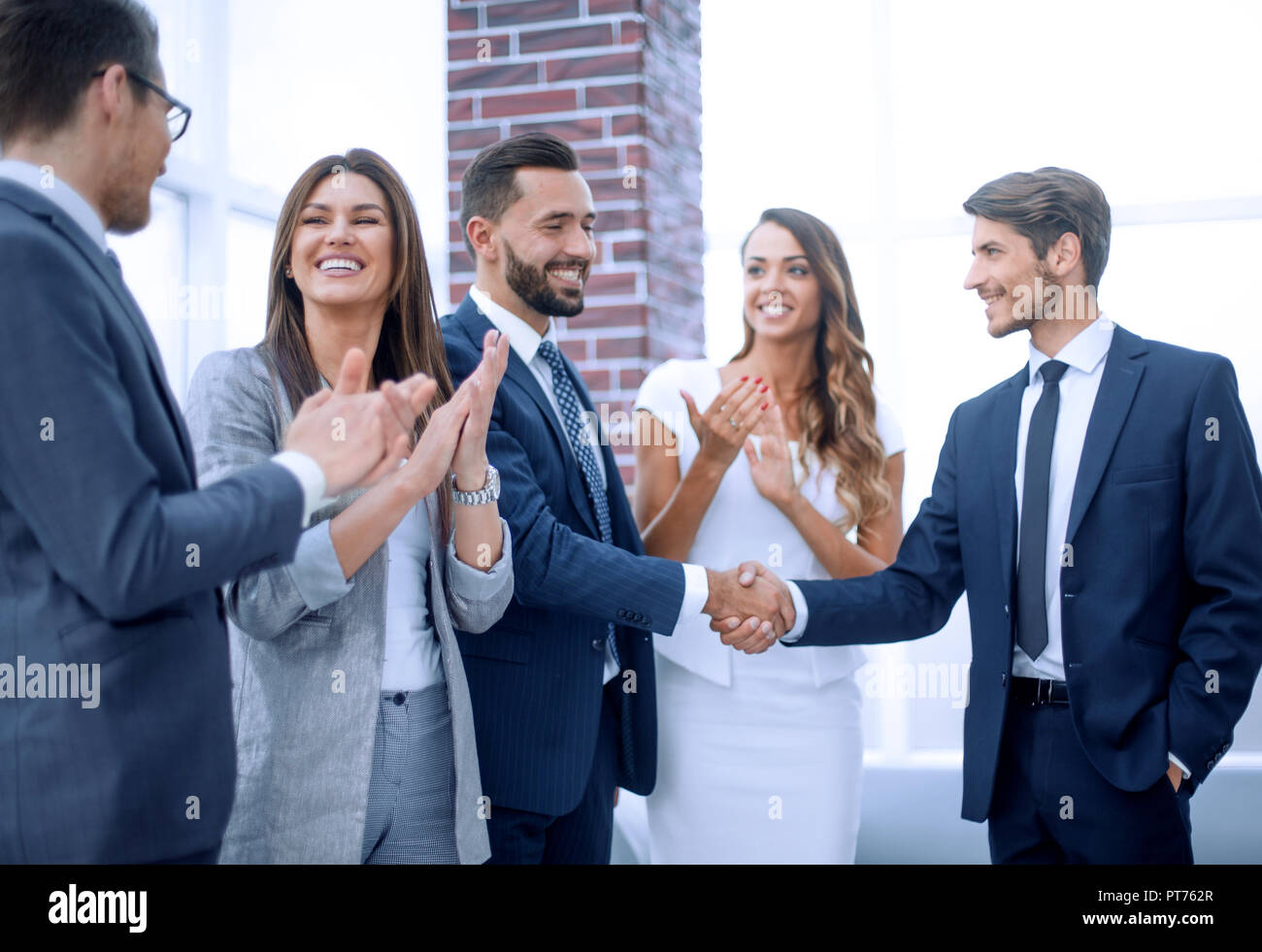 happy business team applauds new business partners Stock Photo - Alamy