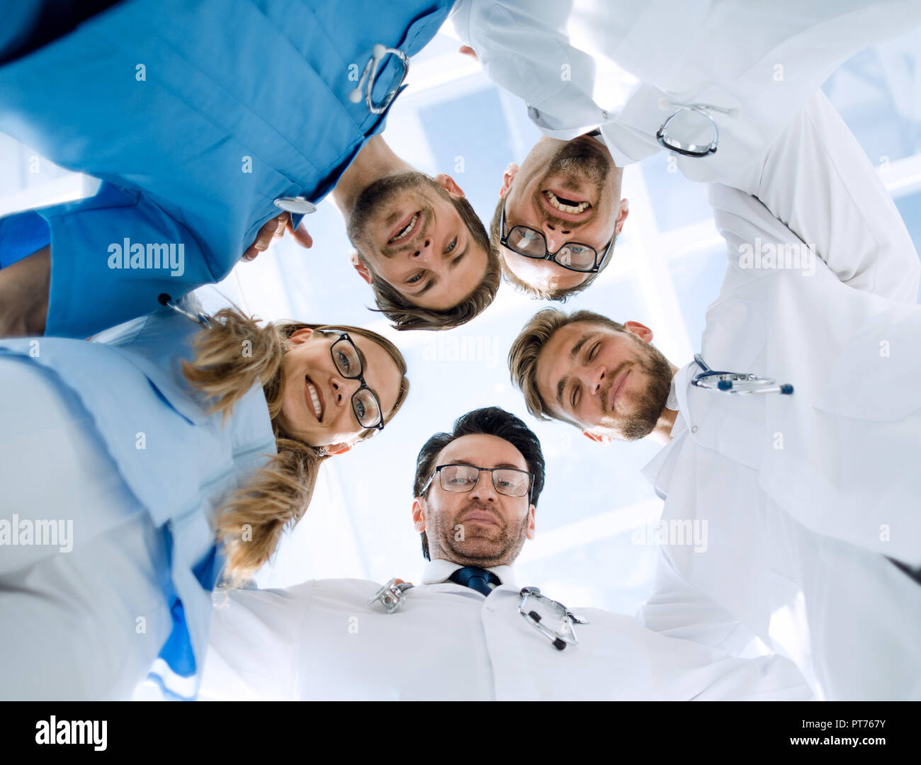 doctors looking down smiling at the camera Stock Photo - Alamy