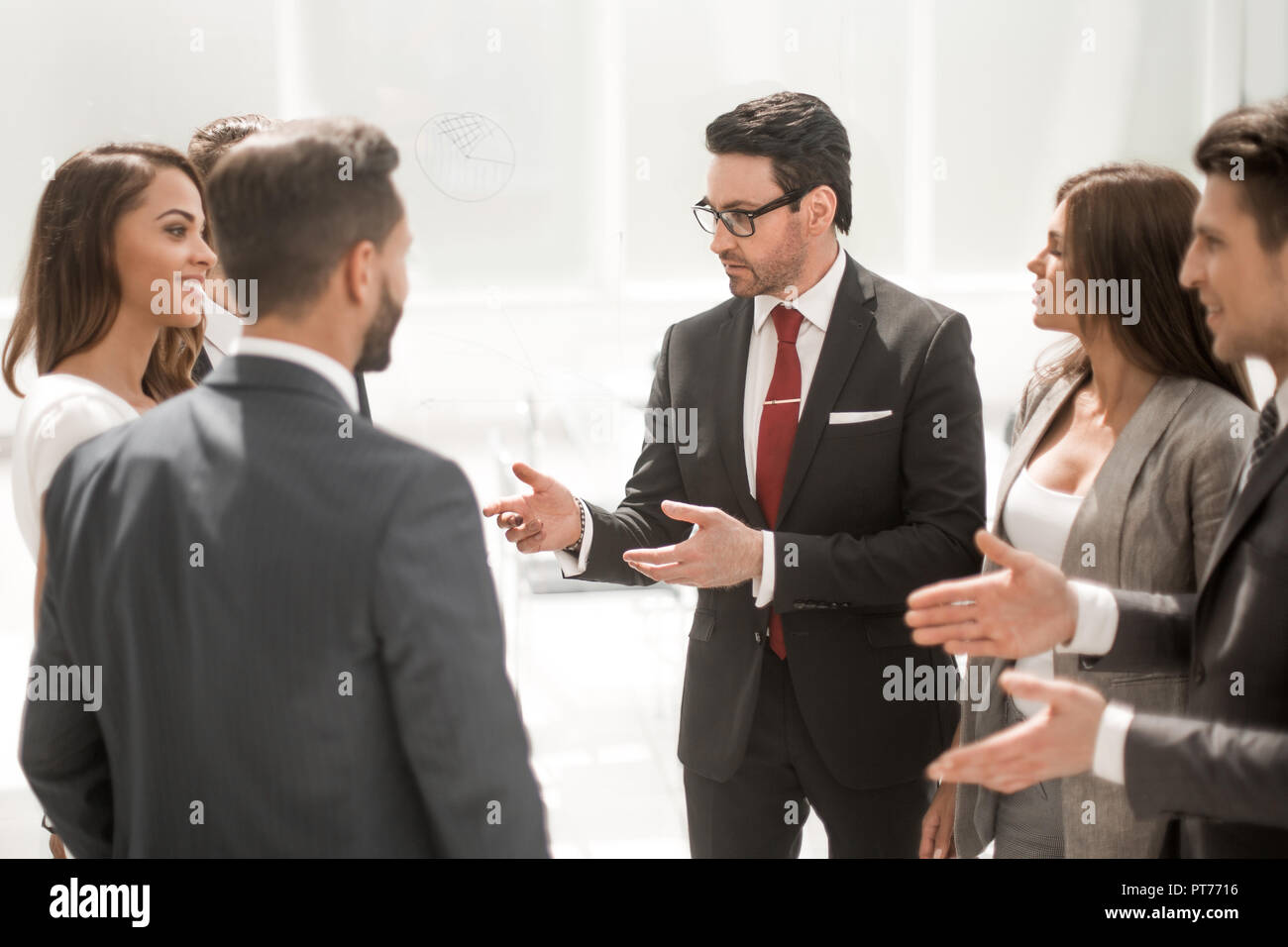close up.a group of employees talking standing in a circle Stock Photo ...