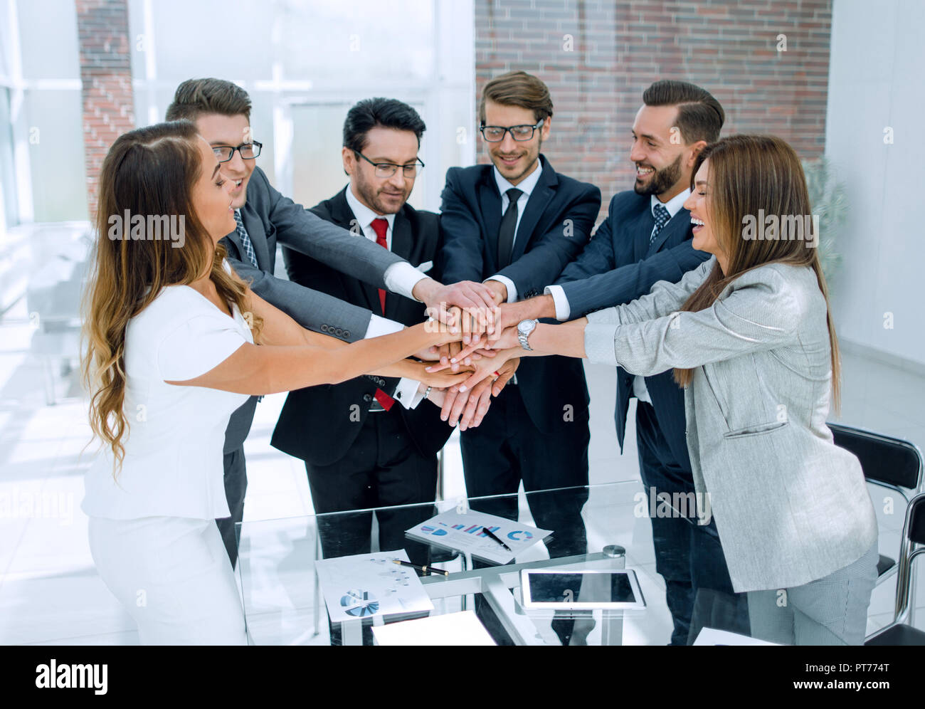 professional business team making tower out of their hands Stock Photo ...