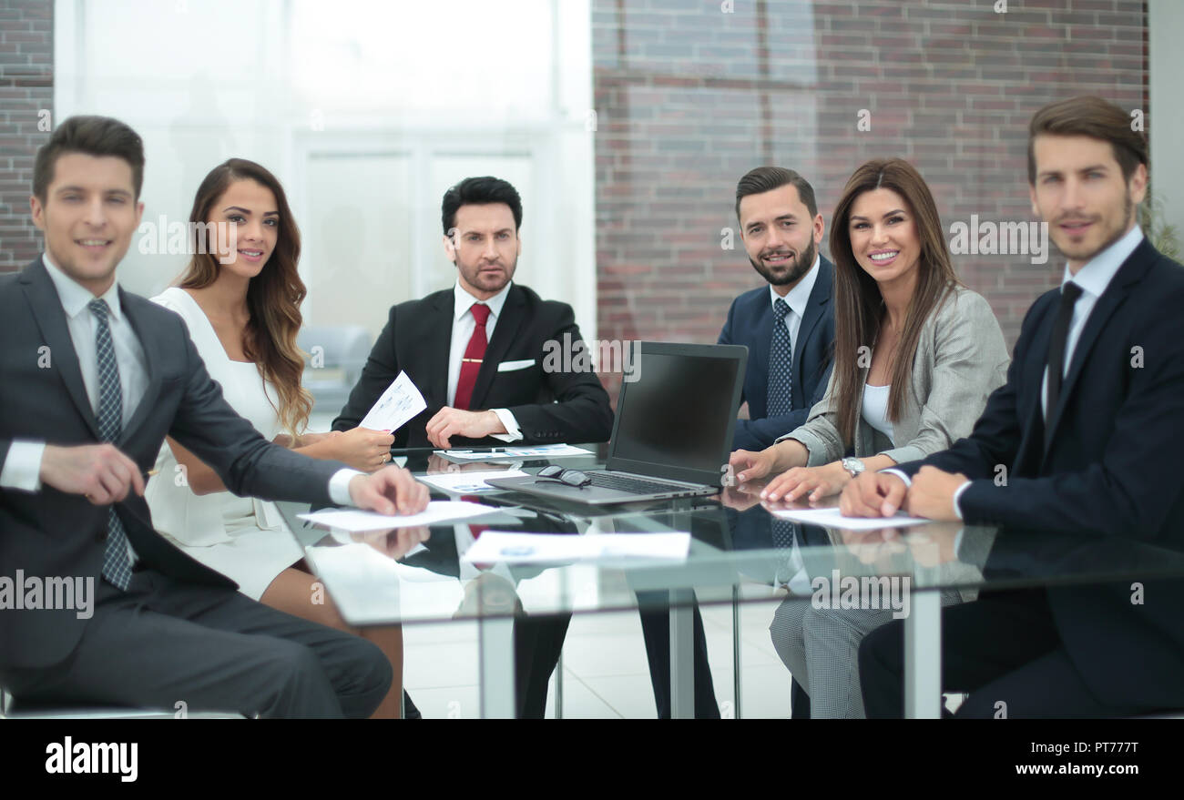 group of business people sitting at the office table Stock Photo - Alamy