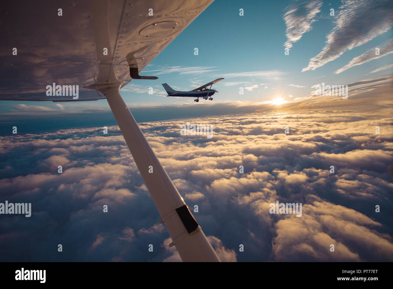 Small single engine airplane flying in the gorgeous sunset sky through ...