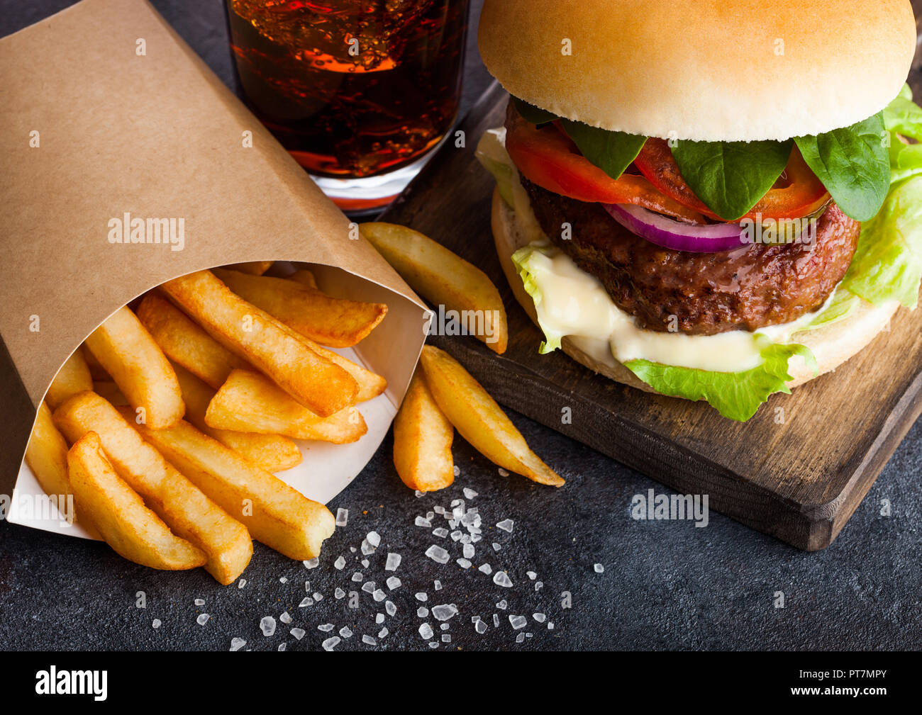 Fresh beef burger with sauce and vegetables and glass of cola soft ...