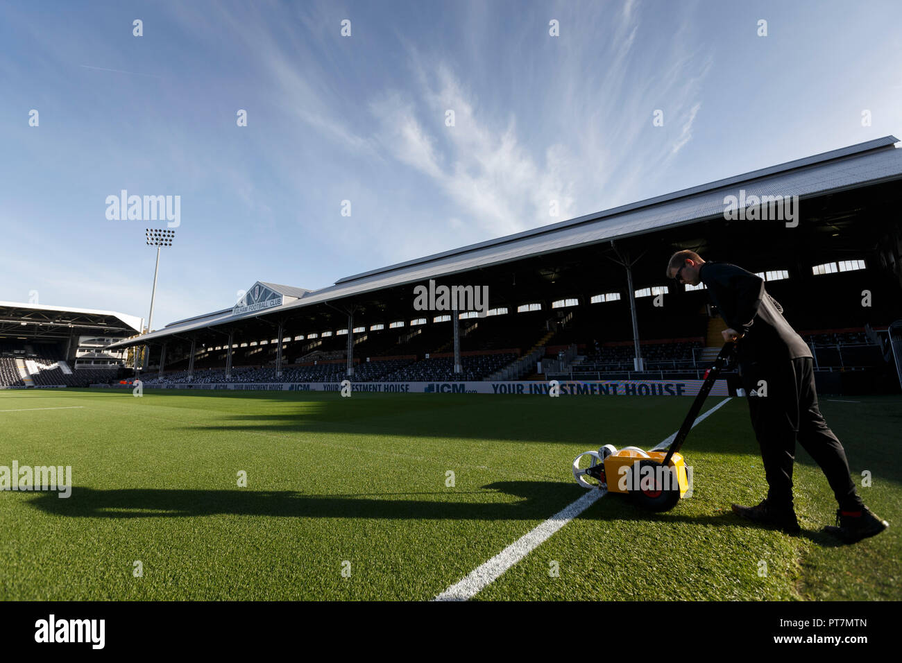 A groundsman prepares the pitch prior to the Premier League match at ...