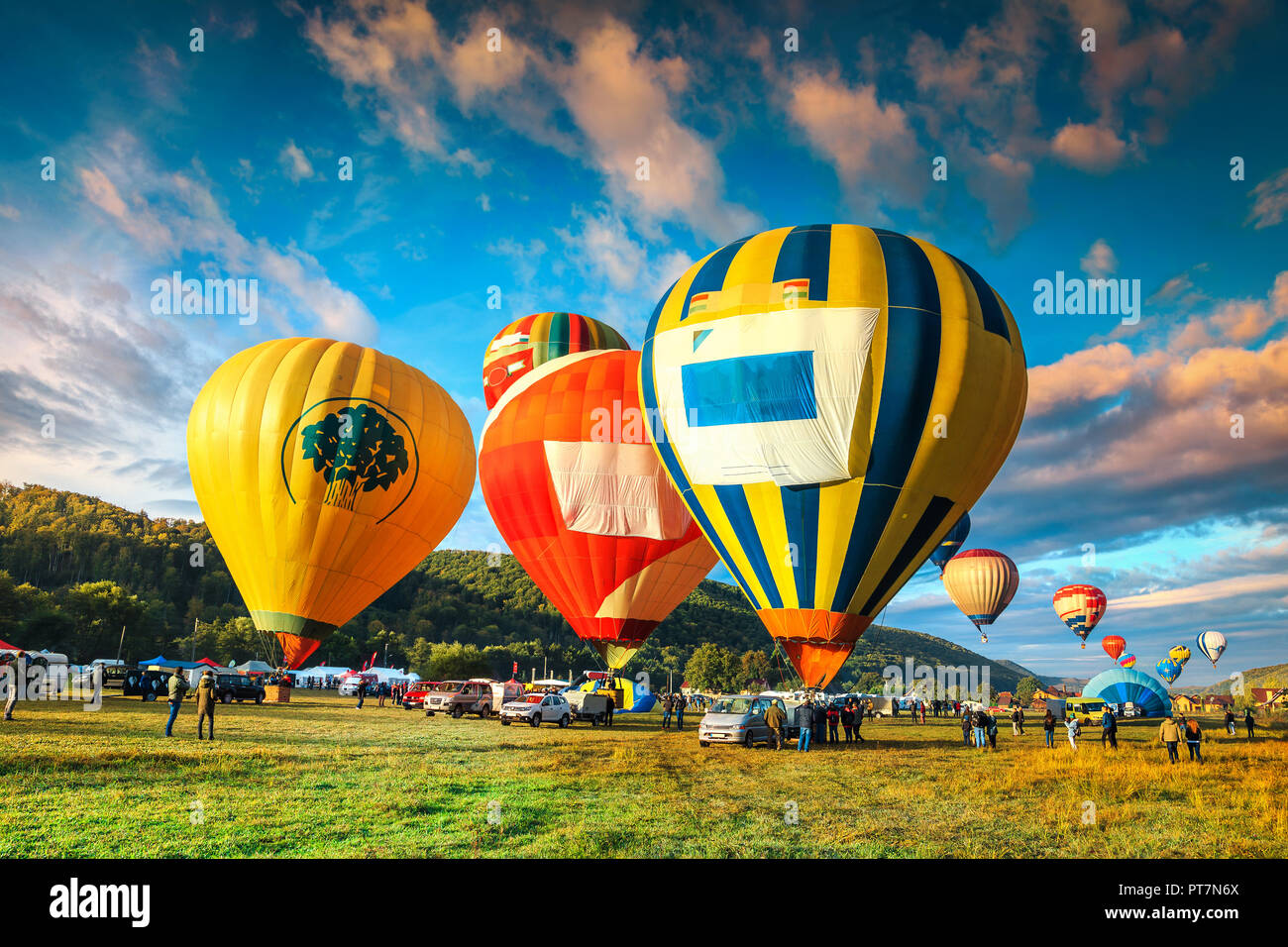 Stunning colorful hot air balloons preparing to rise in the early ...