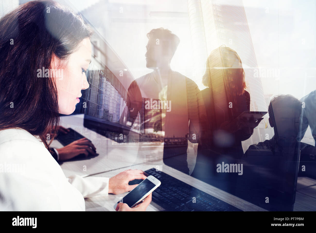 Business people work together in office with workstation in the ...
